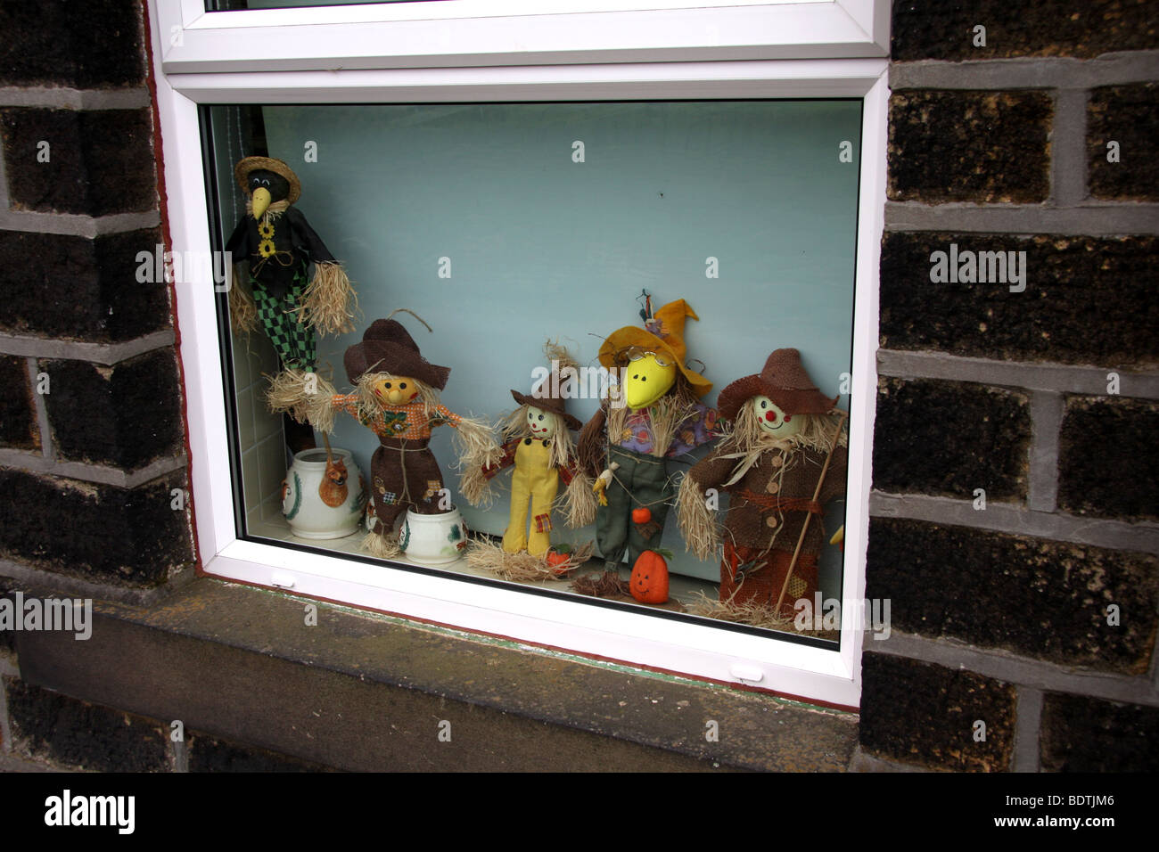 Scarecrow dolls on window Stock Photo - Alamy