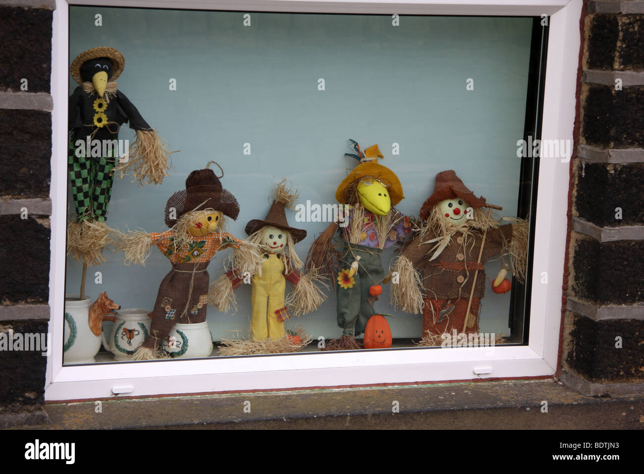 Scarecrow dolls on window Stock Photo - Alamy