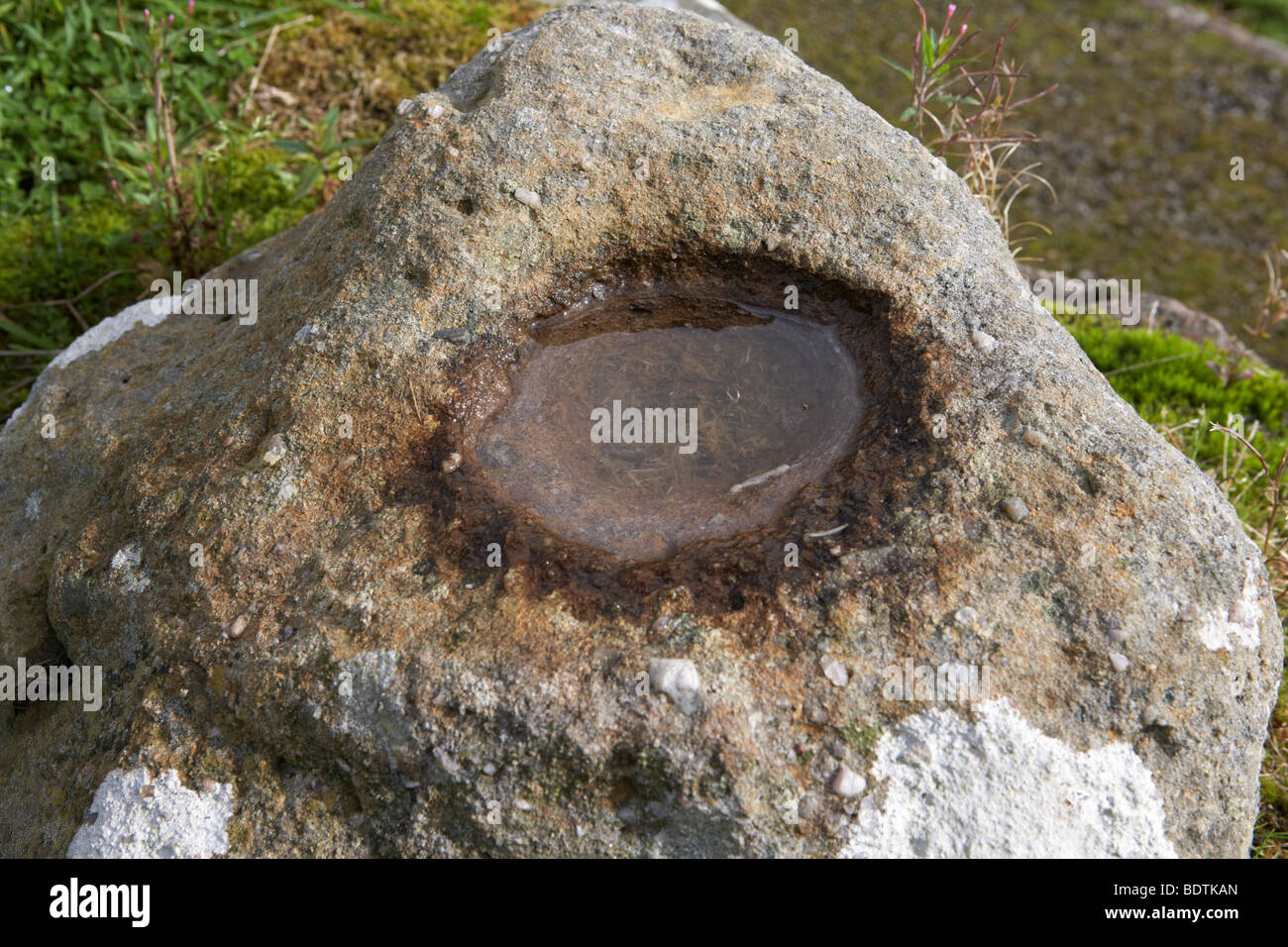 ancient irish bullaun stone or font the ruins of St Kierans errigal ...