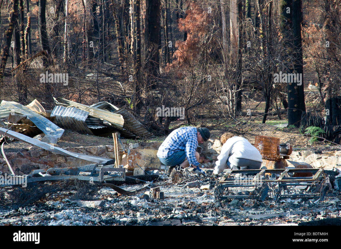 People looking for remains after a bushfire, Marysville, Victoria ...