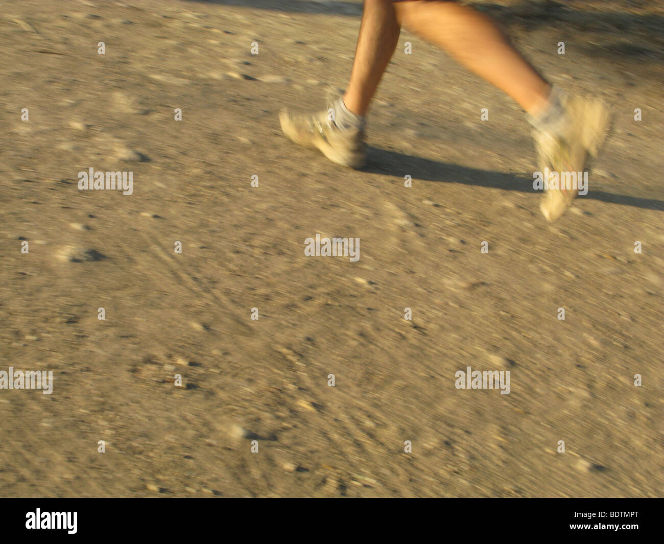 runner in action on footpath in sun Stock Photo - Alamy