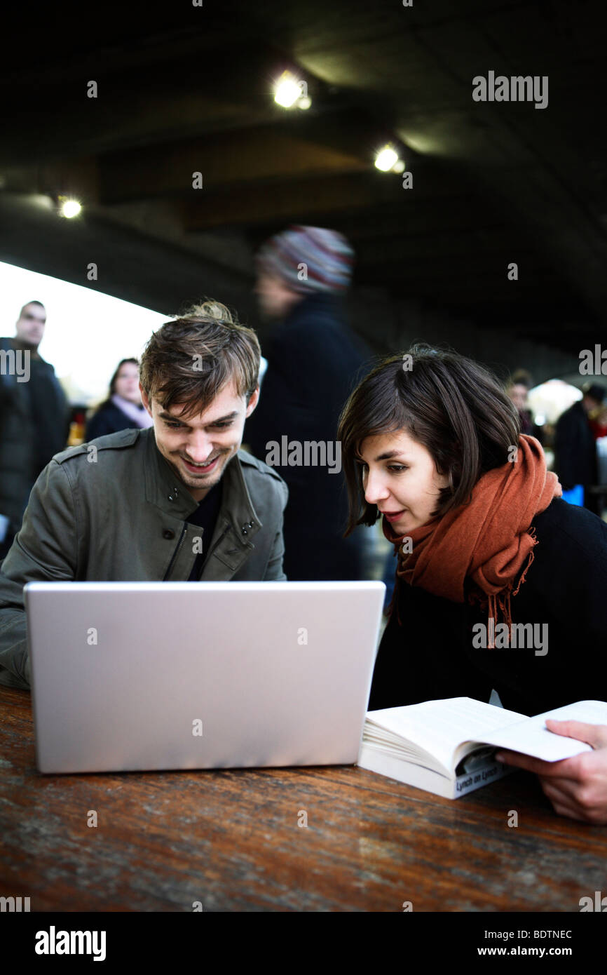A couple in London using a laptop Stock Photo - Alamy