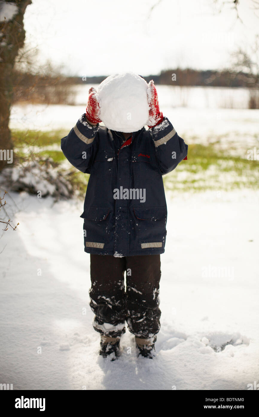 Boy hiding ehind a snowball gotland hi-res stock photography and images ...
