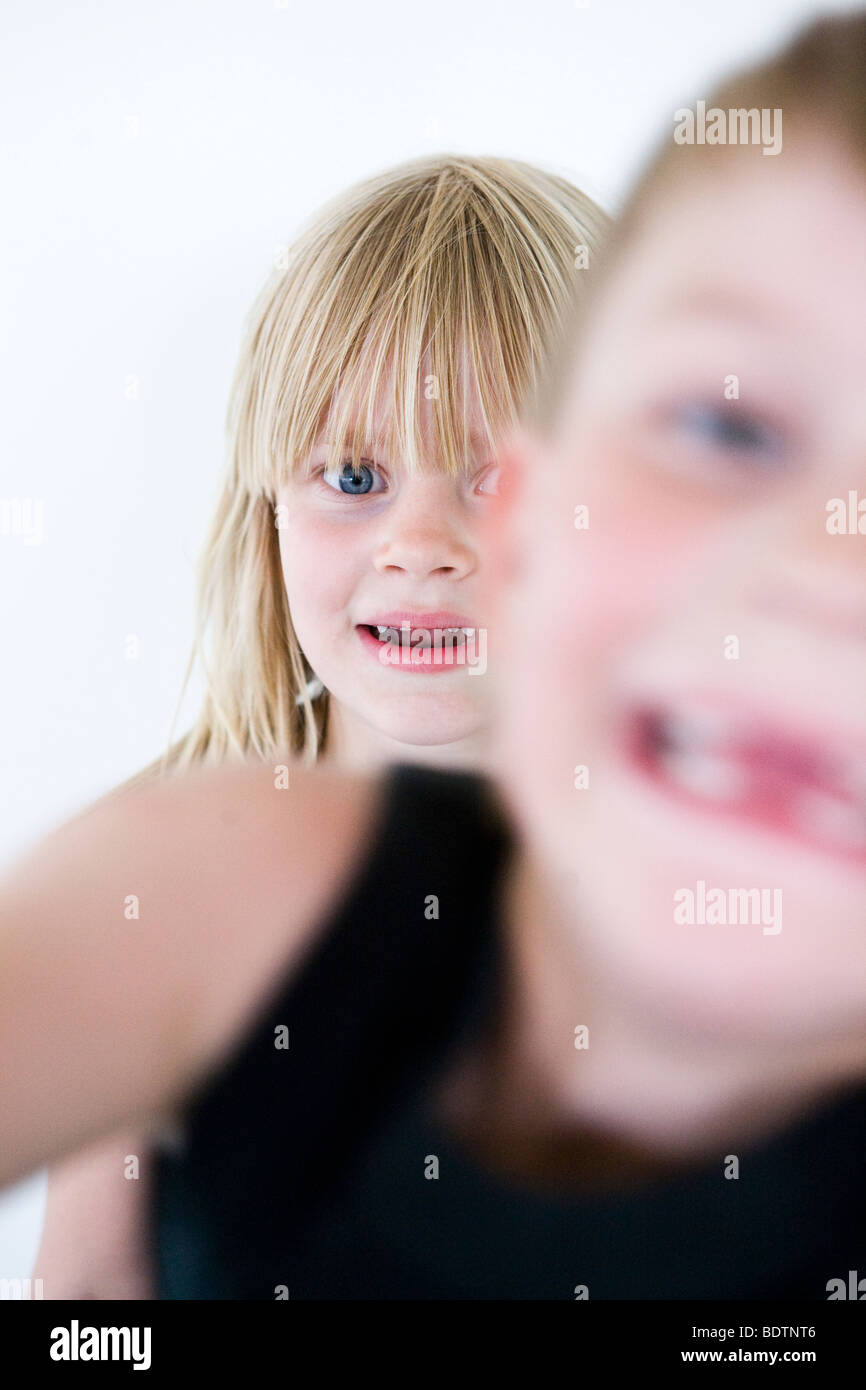 Two children looking into the camera Stock Photo - Alamy