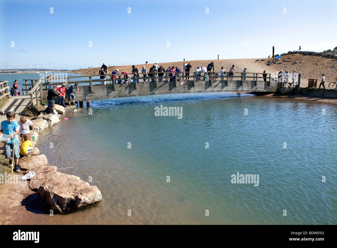 Holidaymakers crab fish at Hurst Spit, Keyhaven, Hampshire, England ...