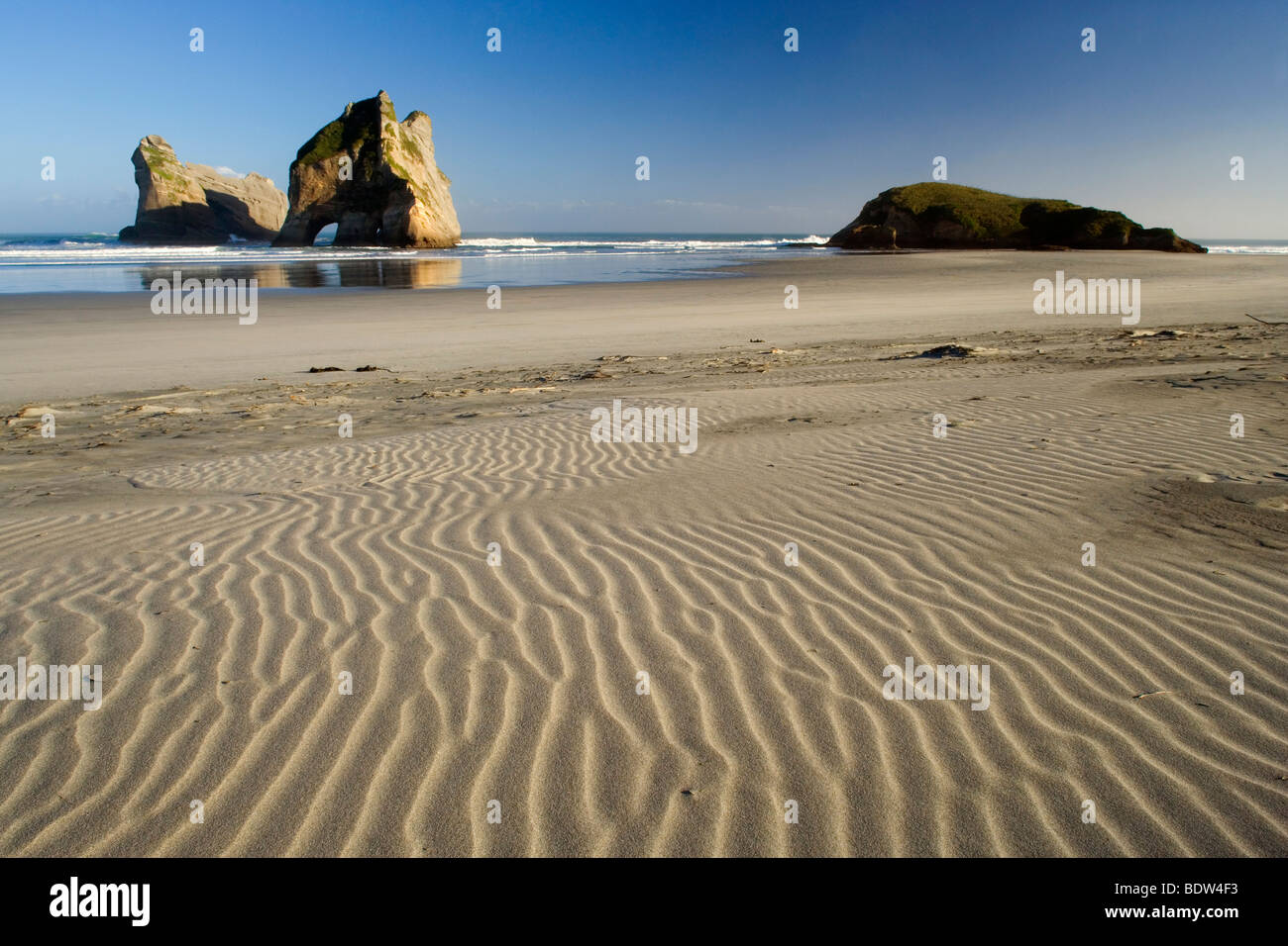 sand dunes and by powerful surf sculpted rock islands with caves and ...