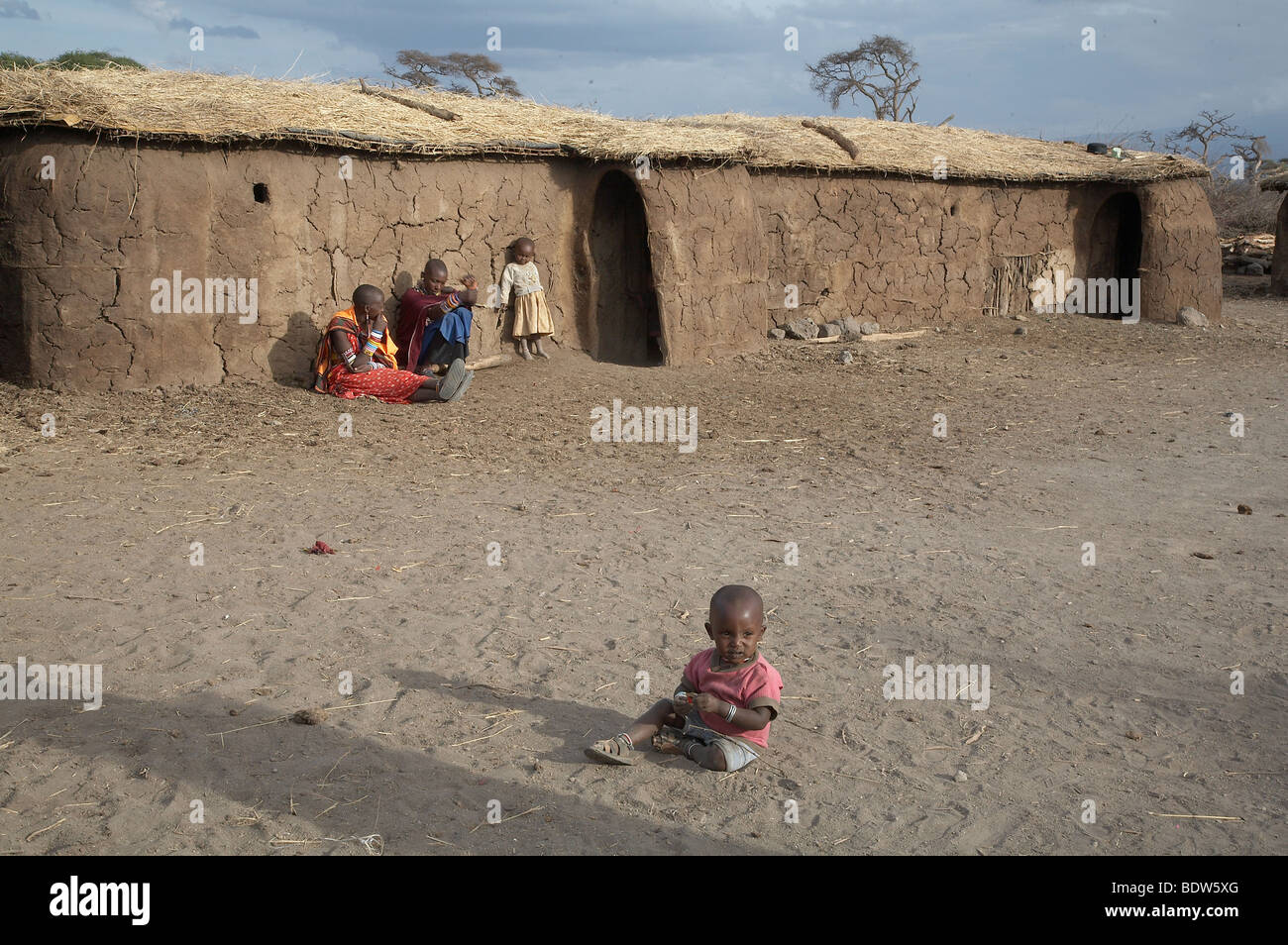 KENYA Masai warrior and 'boma' or traditional house made from sticks ...