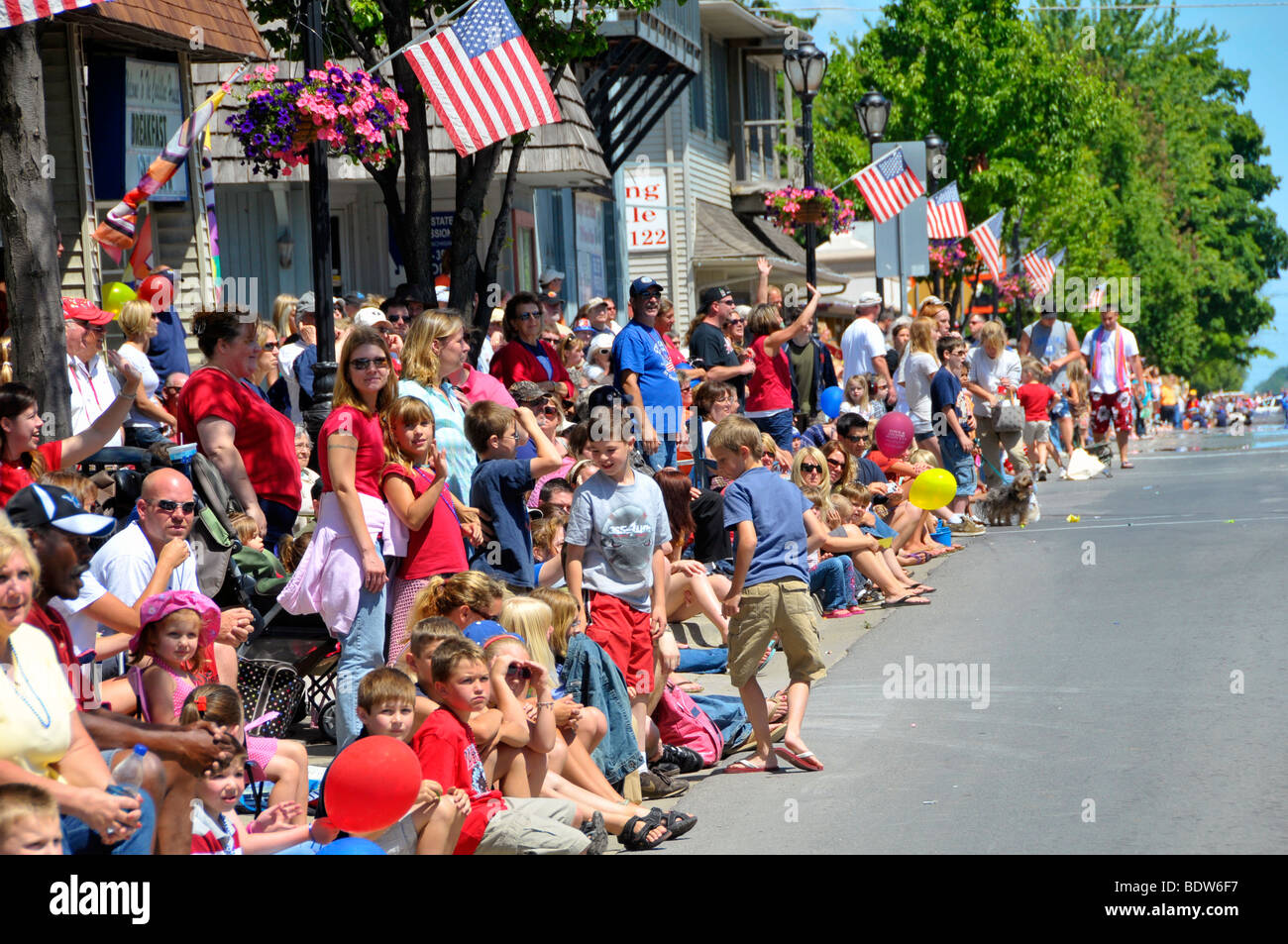 Crowd lines street watching patriotic parade Stock Photo - Alamy