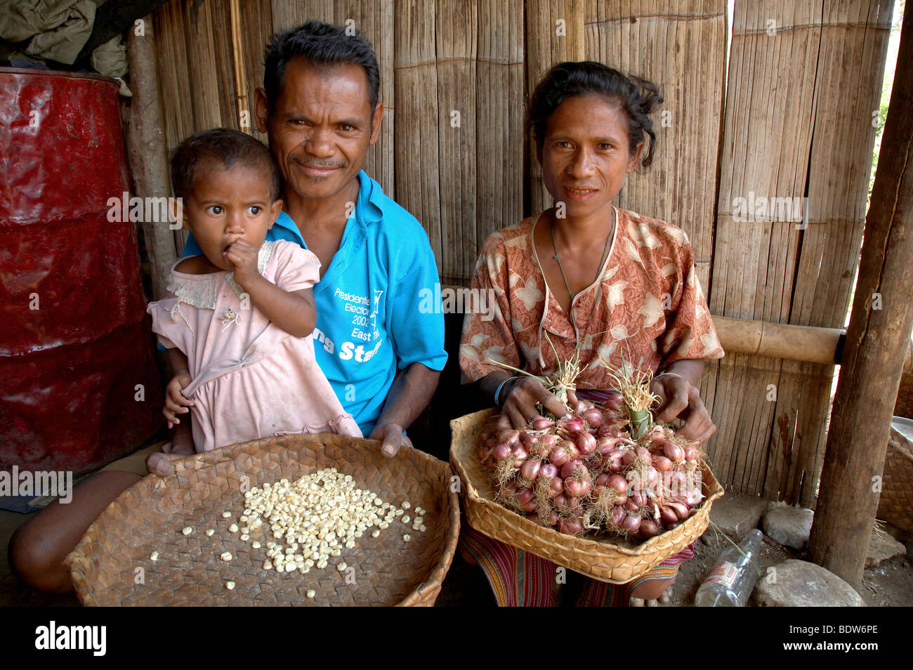 TIMOR LESTE Husband and wife with maize seeds and onions which they ...