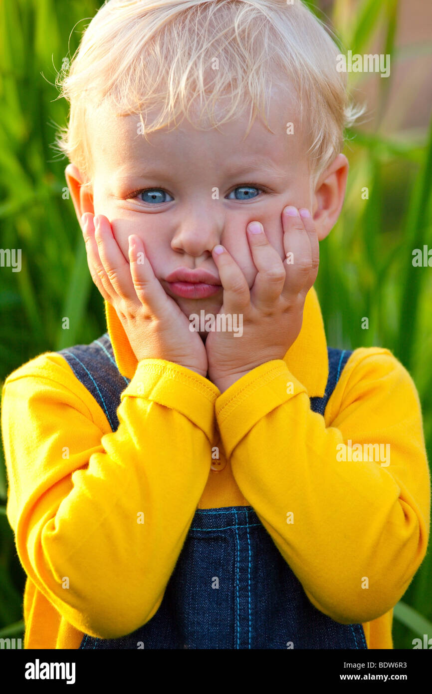 the little boy is happy to look poses before the camera Stock Photo - Alamy