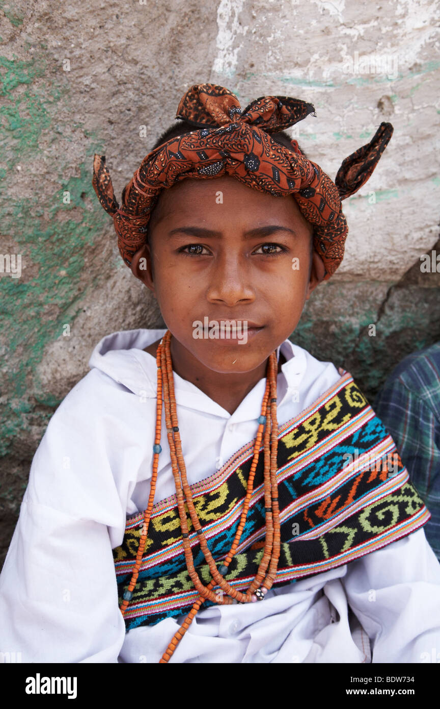 TIMOR LESTE Boy wearing traditional dress including ikat weaves and ...