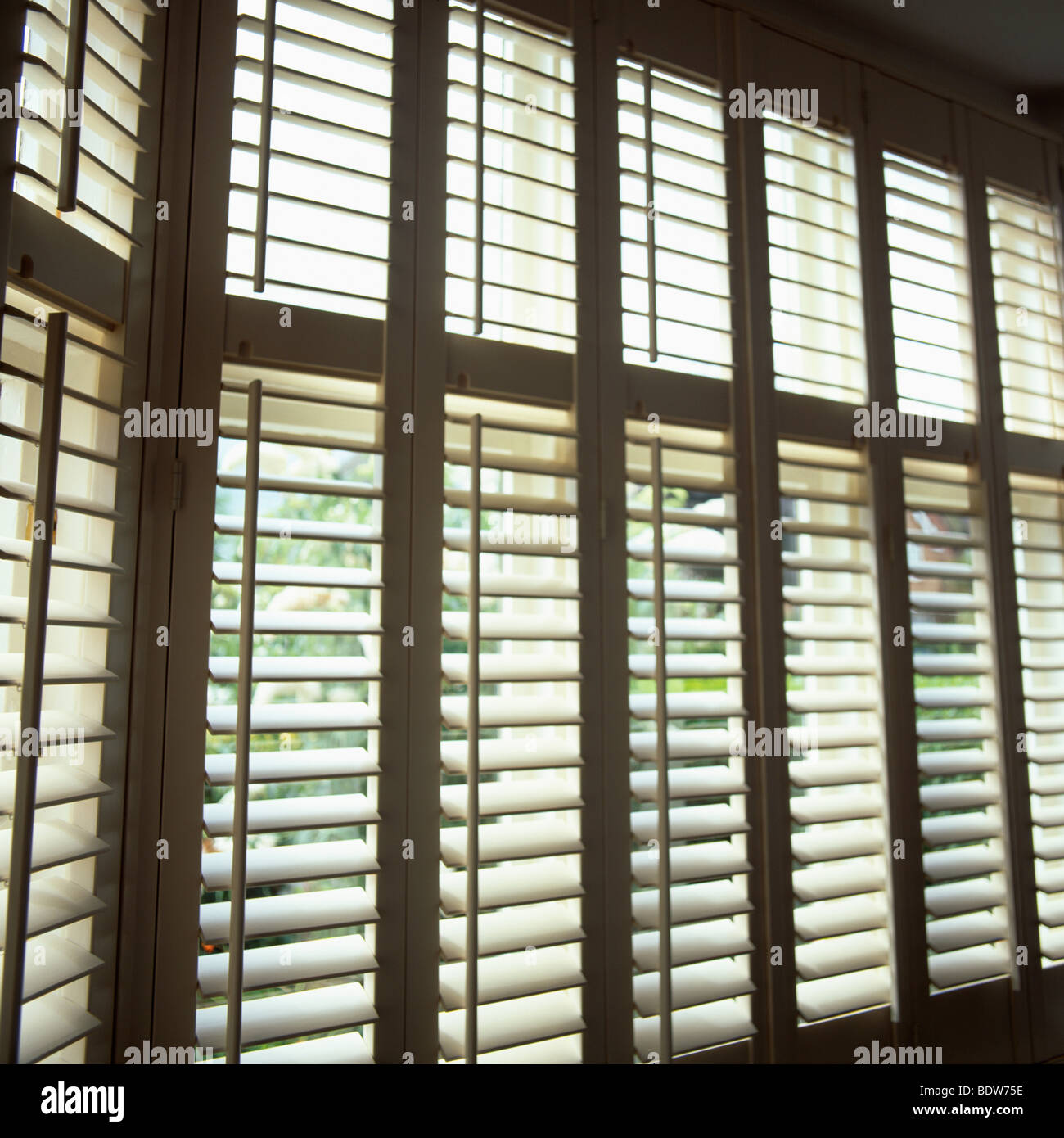 Window shutters with sunlight streaming in Stock Photo - Alamy