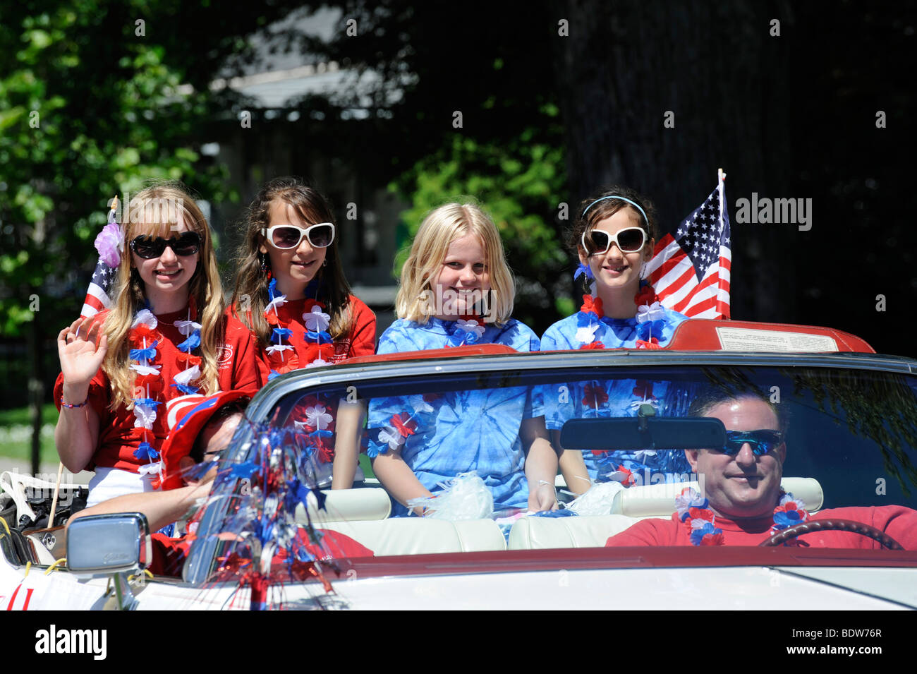 Young girls in open convertible in patriotic parade Stock Photo - Alamy
