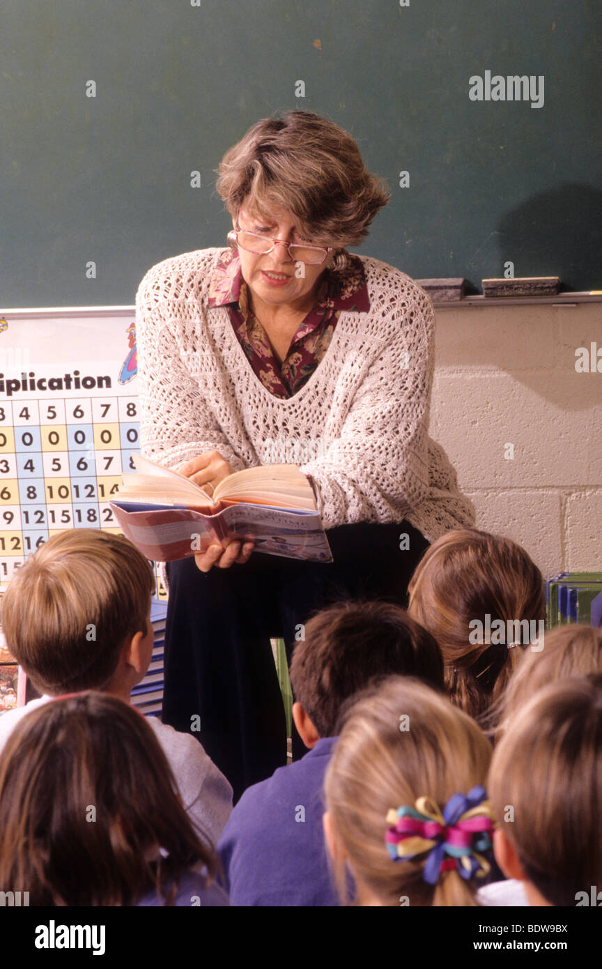 female instructor reads book to her class Stock Photo - Alamy