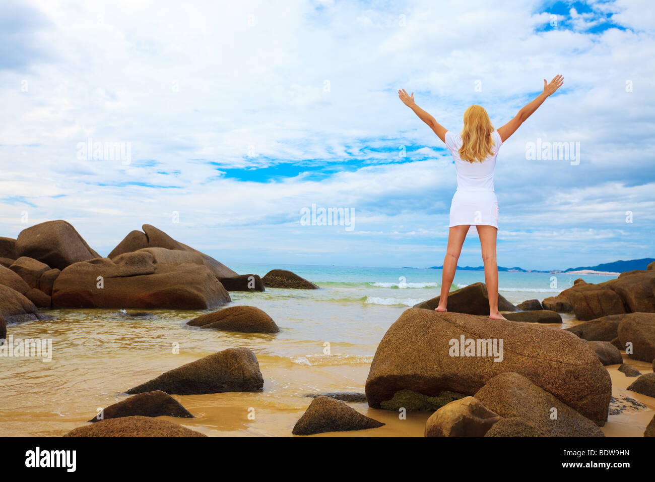 Woman with opened hands near the ocean Stock Photo - Alamy
