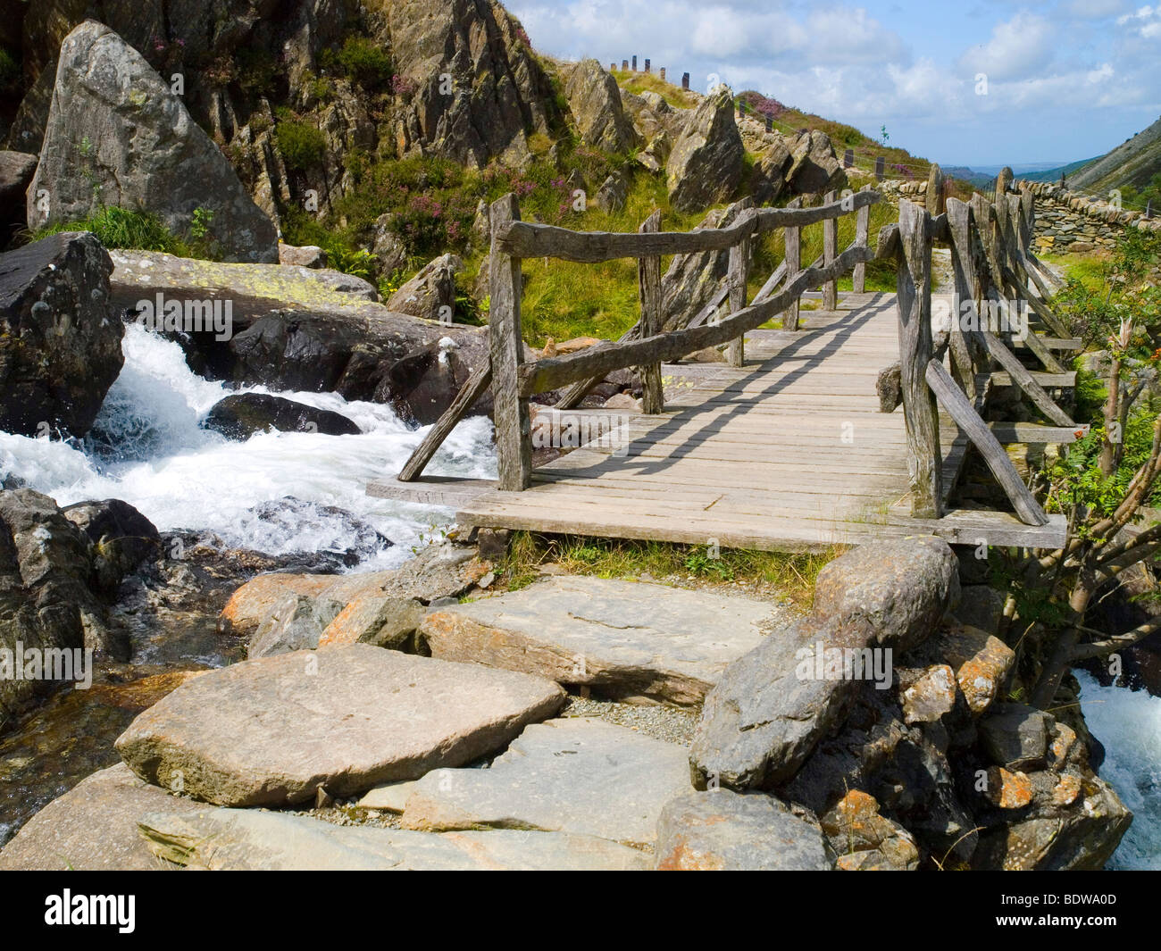 A footbridge over a waterfall by Ogwen Cottage Outdoor Pursuits Centre ...