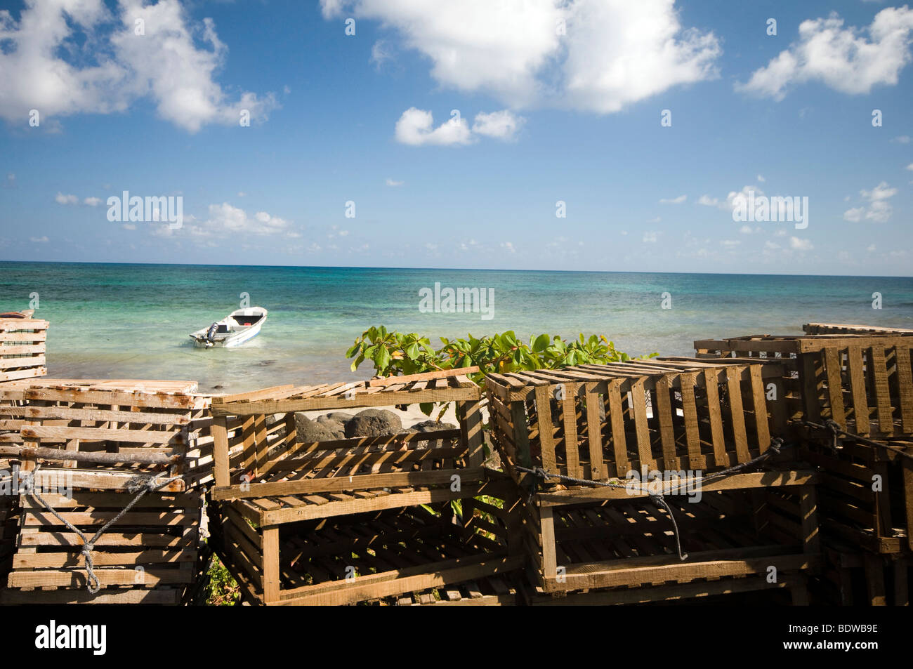 lobster pot traps and native fishing boats on shore of caribbean sea ...