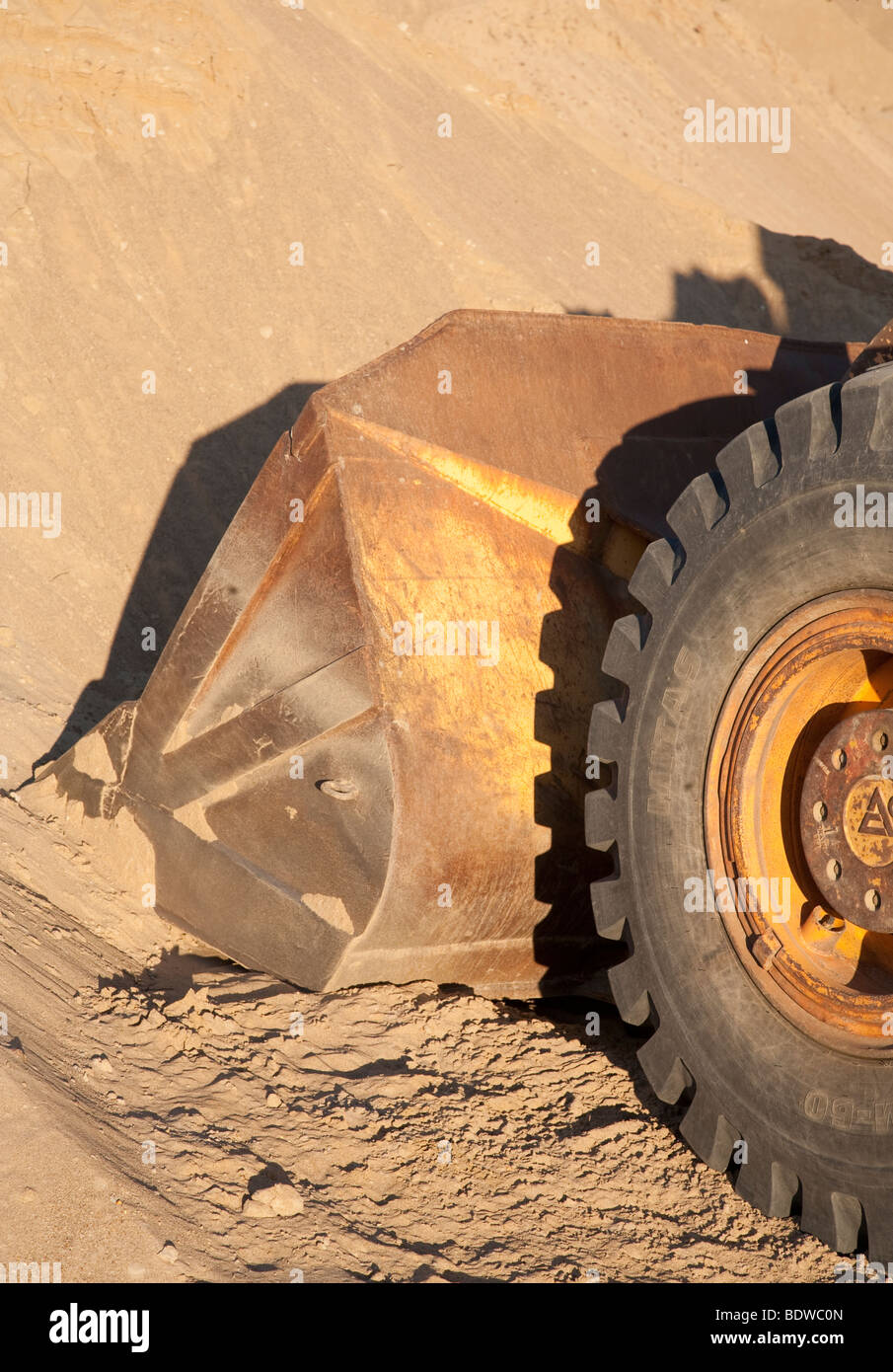 Earth mover tire and bucket Stock Photo - Alamy