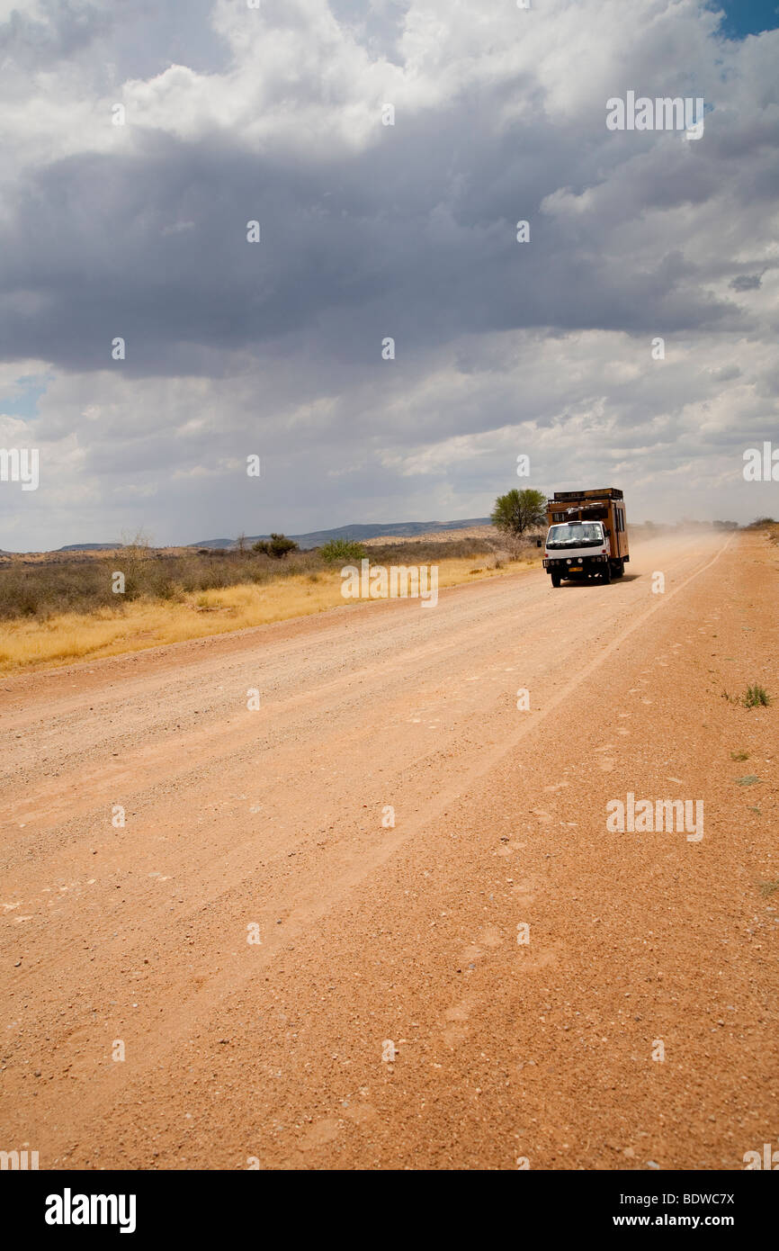 Isolated and dusty unsurfaced road with lone truck, Namibia Stock Photo ...