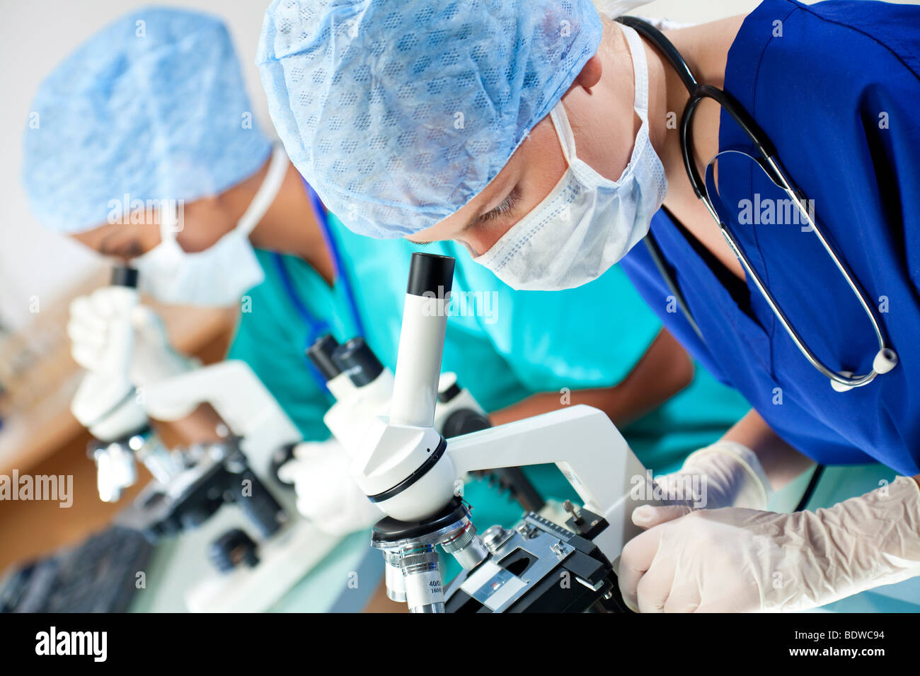 A female medical or scientific researcher or doctor using her ...