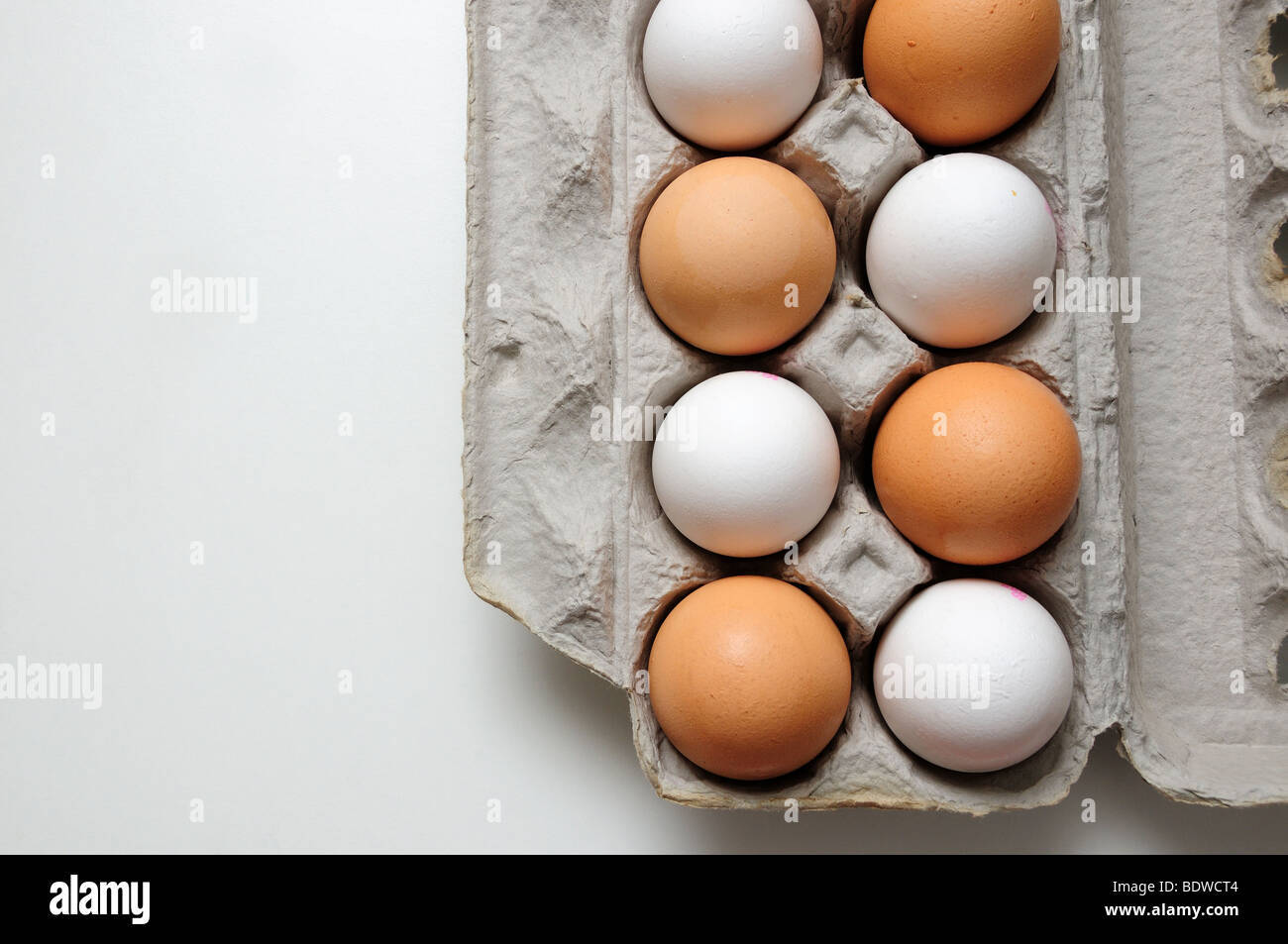 White and brown organic eggs in a paper carton Stock Photo - Alamy