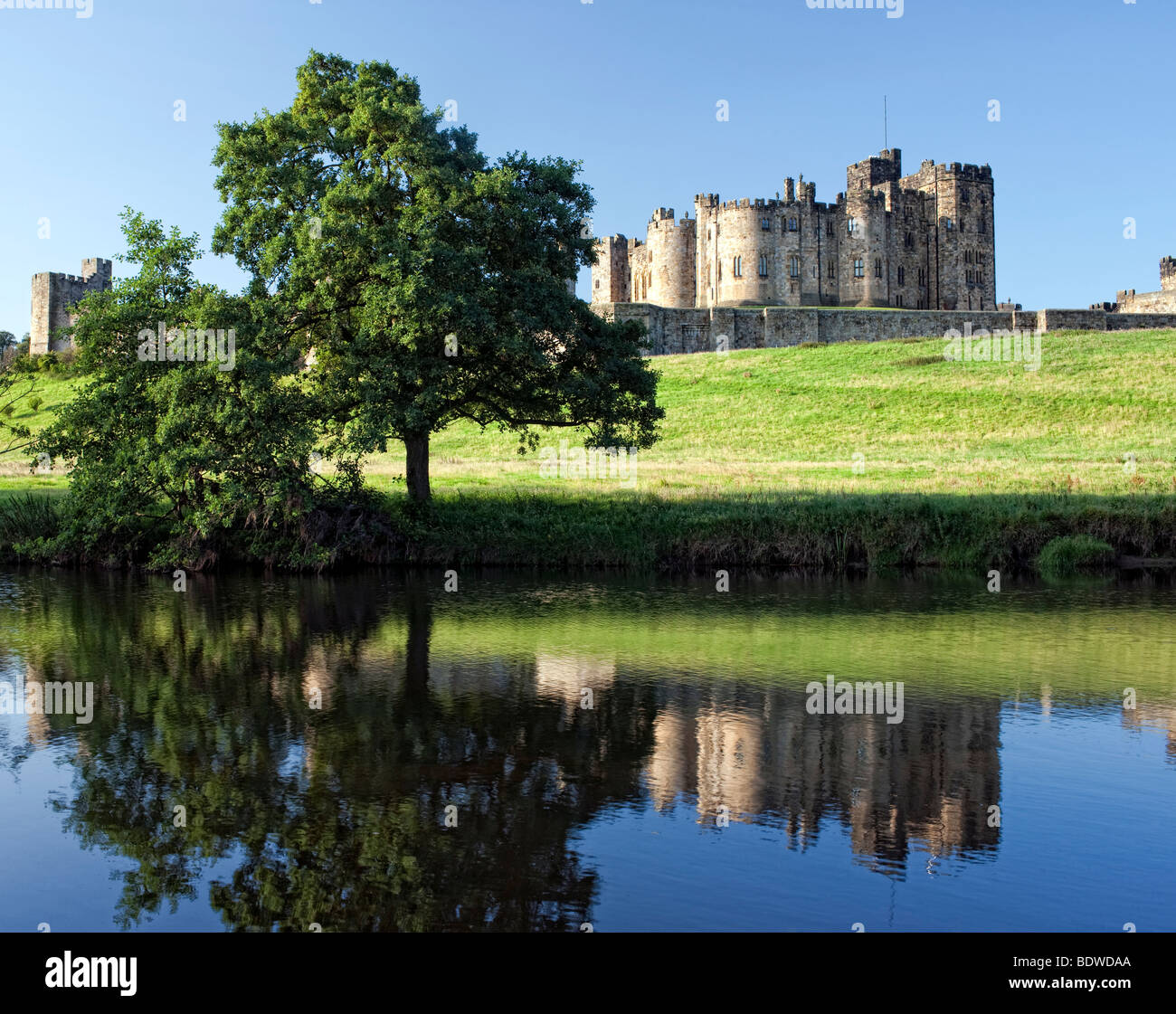 Alnwick castle from the banks of the River Aln on a sunny summer's ...
