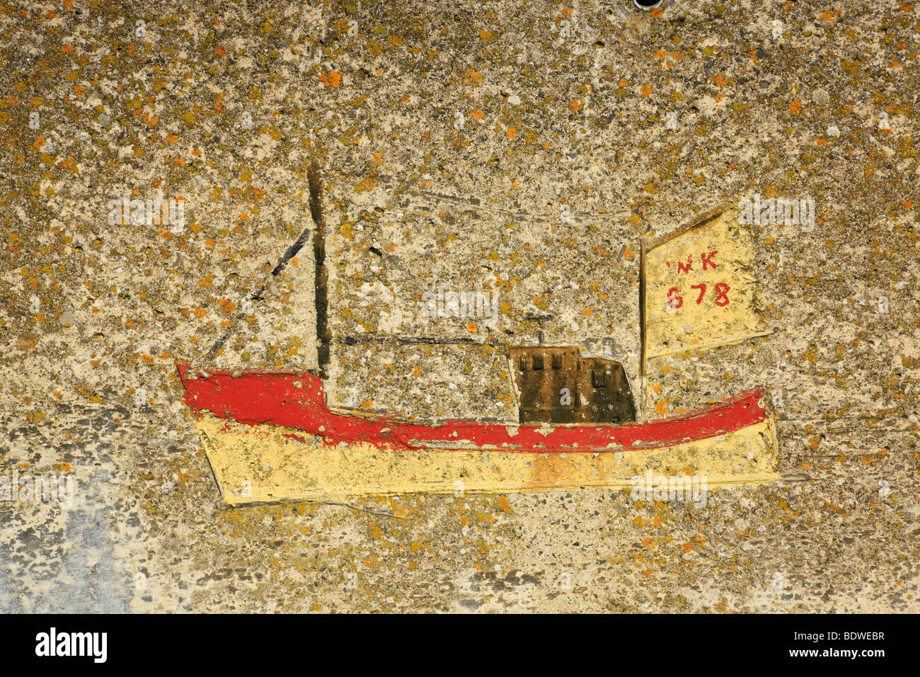 Pictures of boats are etched and painted into the concrete harbour ...