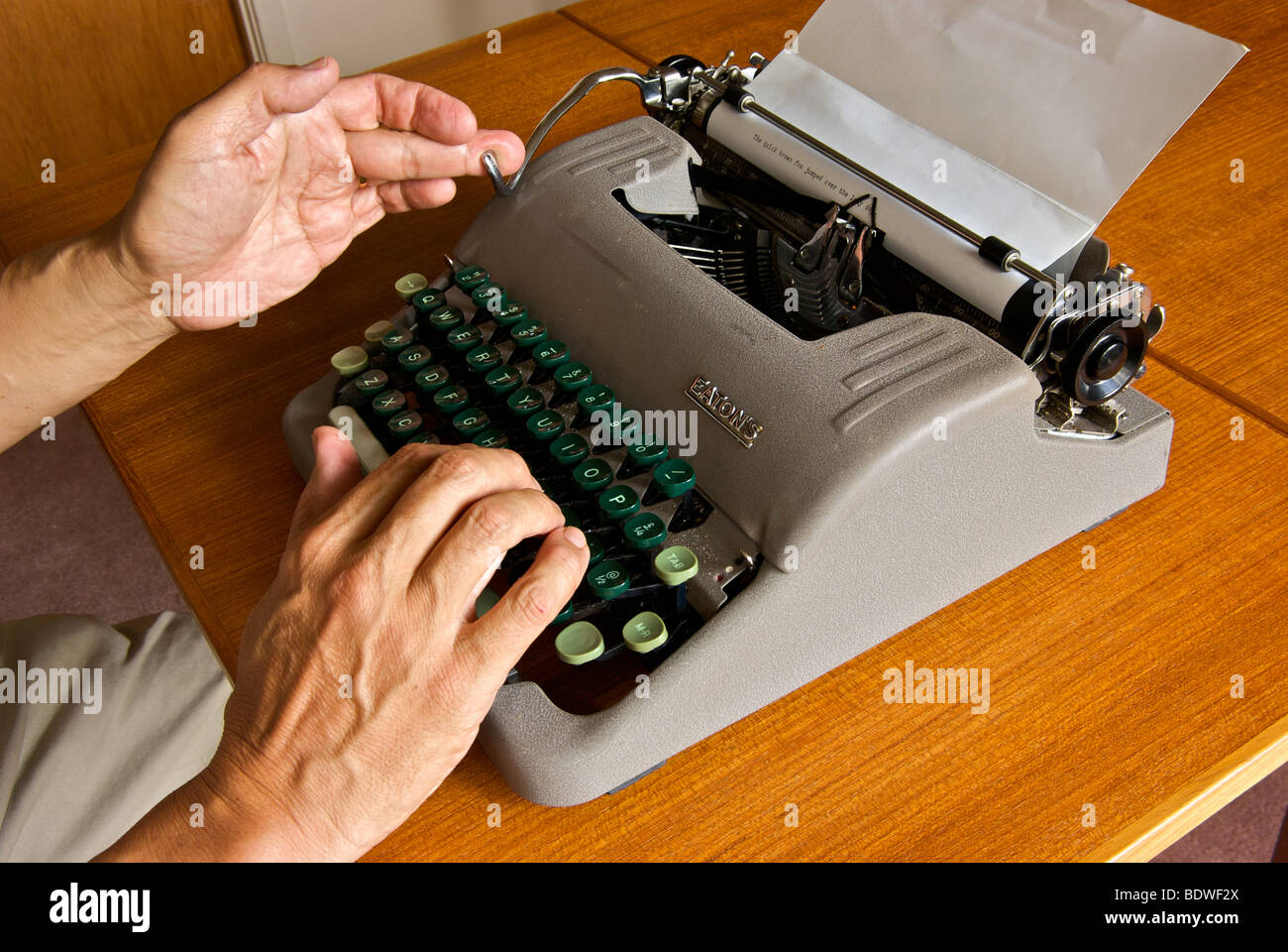 Outdated technology manual portable typewriter finger pushing on ...