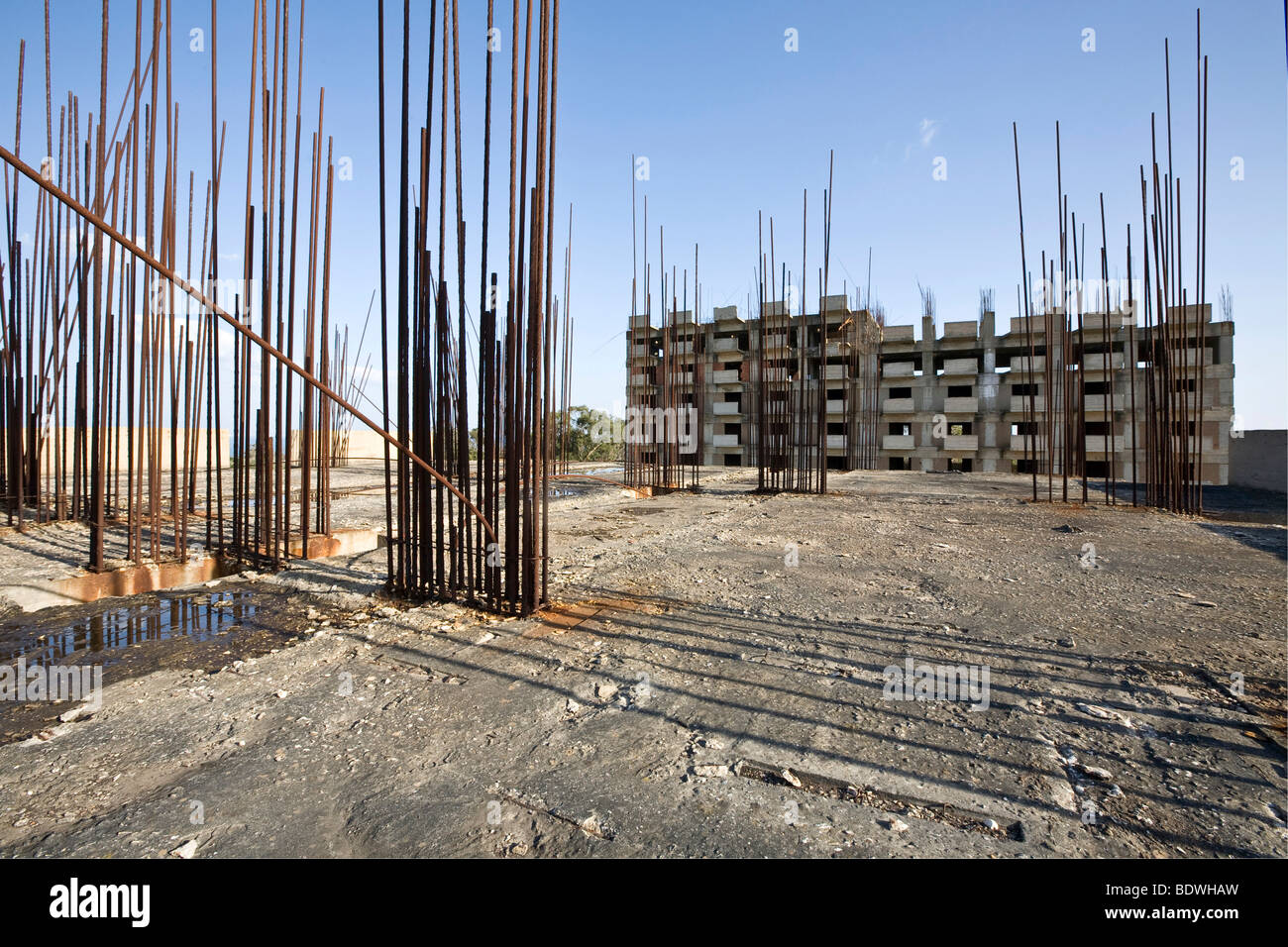 Steel struts, steel wire on the roof of unfinished hotel building ruins ...