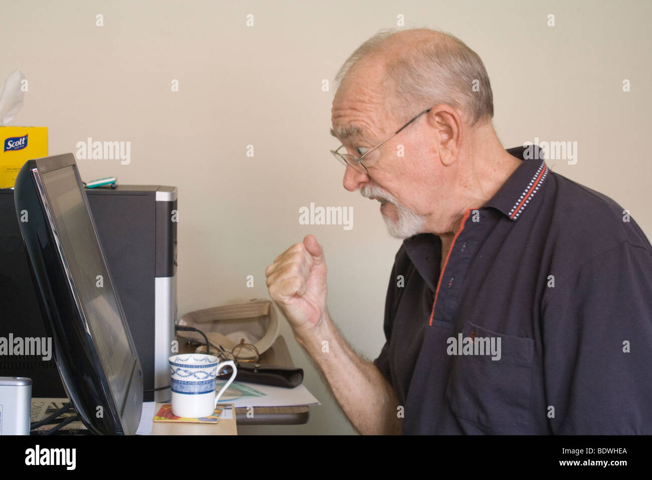 Man at computer showing emotions from puzzlement to rage Stock Photo ...