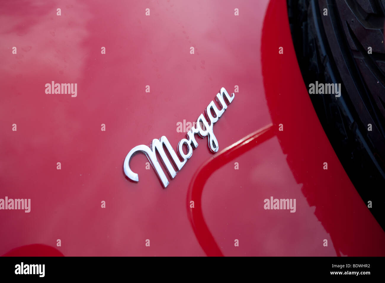 Morgan text logo on red Morgan motor car at centenary celebrations ...