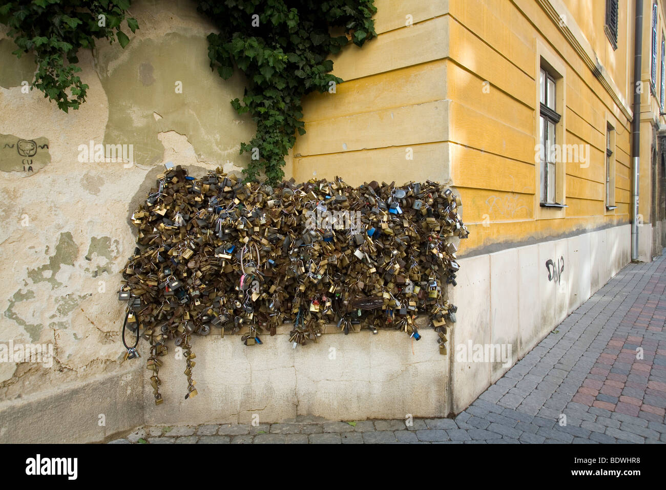 A wall and fence covered in padlocks in Pecs, Hungary Stock Photo - Alamy