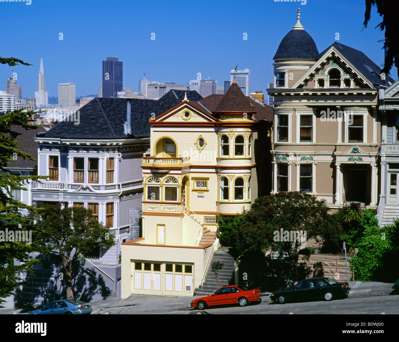 Victorian houses on Alamo Square with the city skyline in the ...