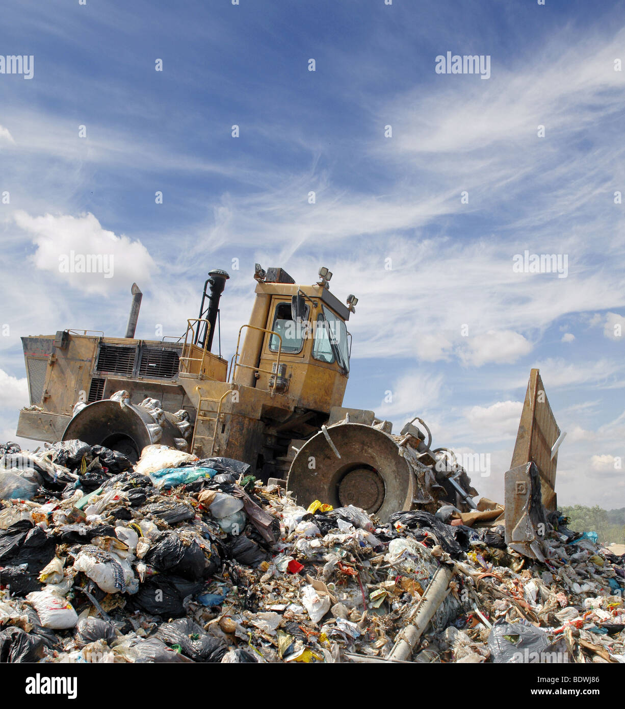 The bulldozer buries food and industrial wastes Stock Photo - Alamy