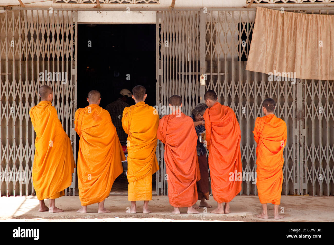 Monks taking morning alms Stock Photo - Alamy