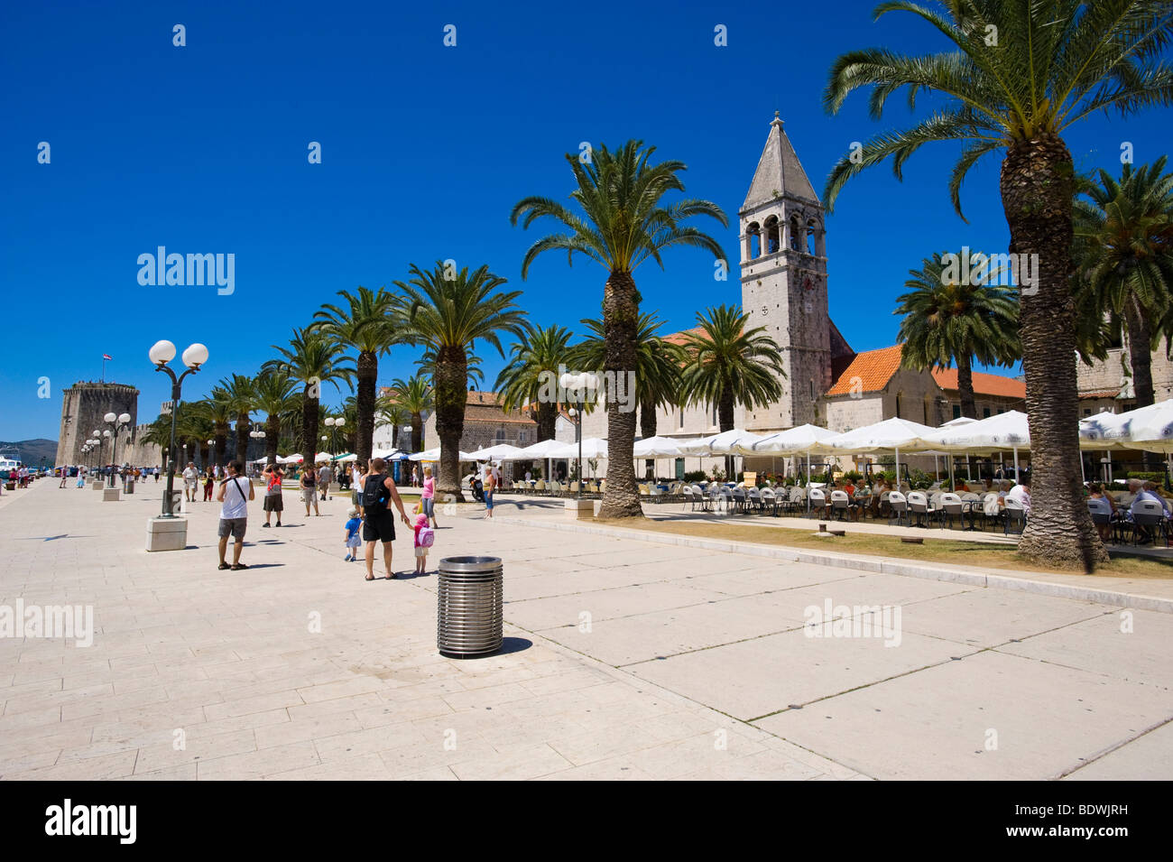 Waterfront promenade of Trogir, on the right bell-tower of the ...