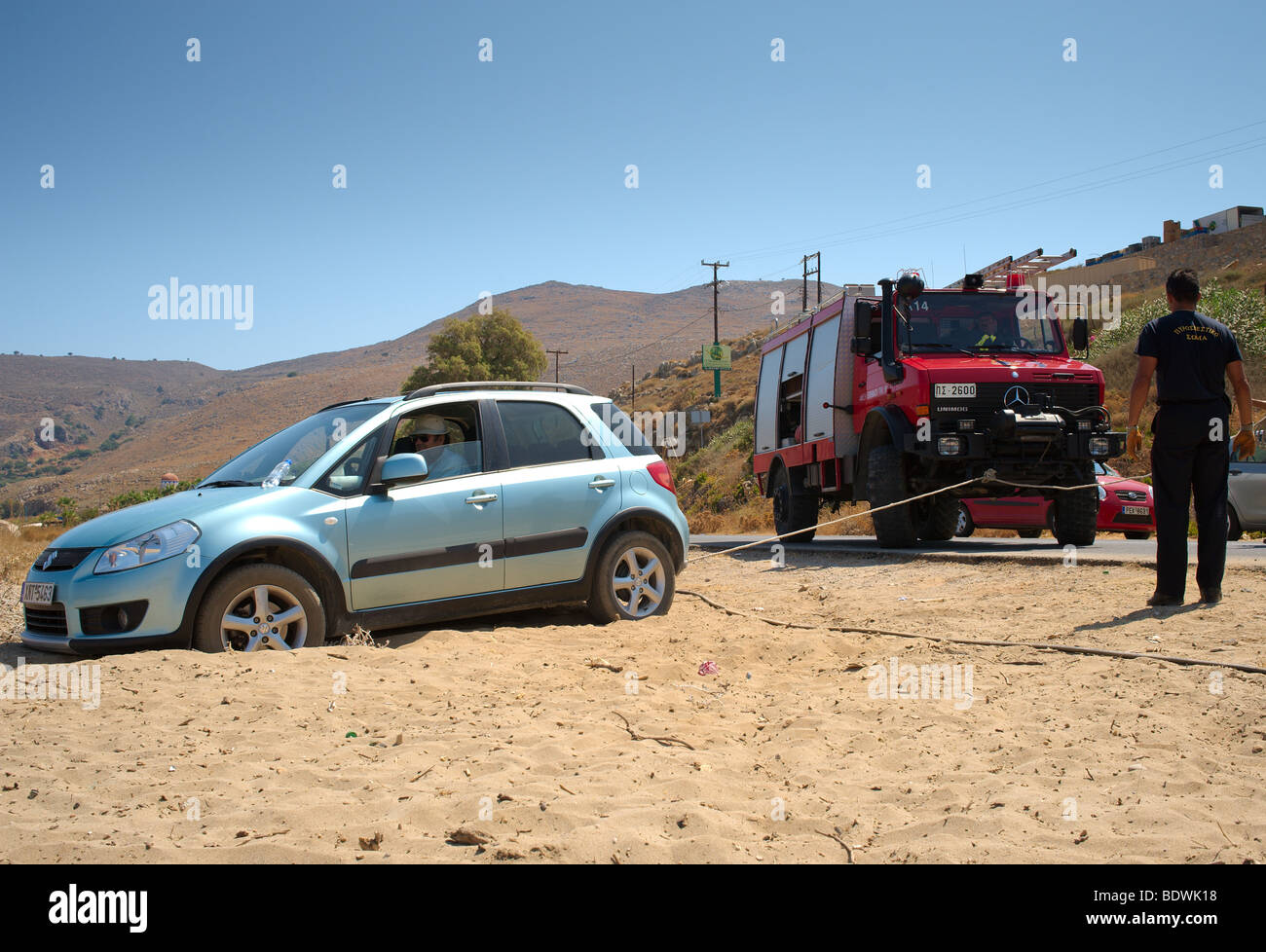 Greek fire engine pulling car from sand Stock Photo - Alamy