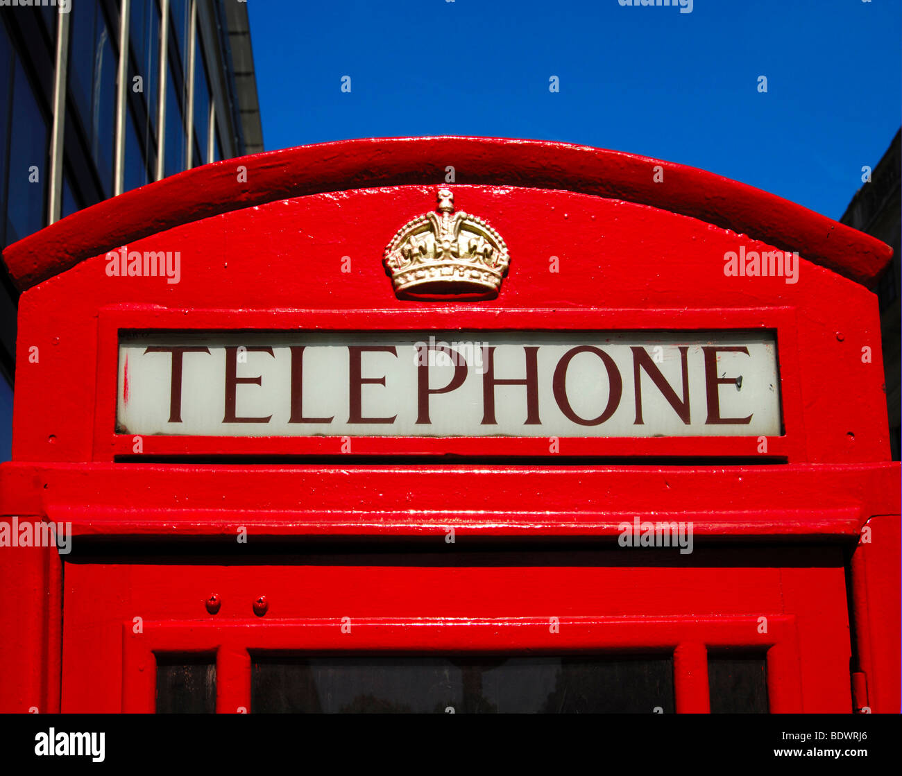 Tradional red telephone box with the St Edward's Crown in the city ...