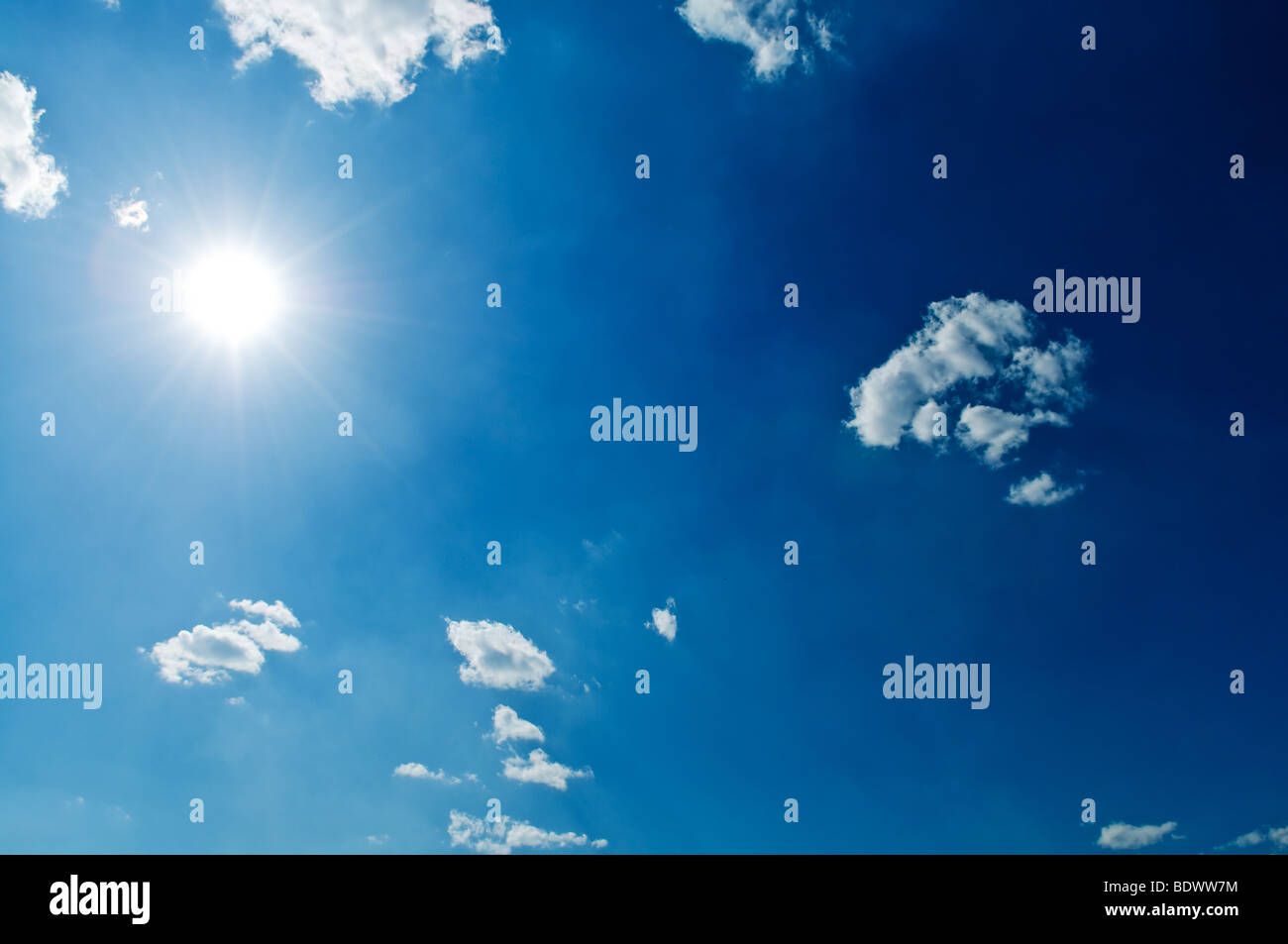Sun with sunlight beams on blue sky Stock Photo - Alamy