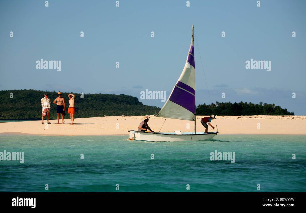 A father and son sail a small yacht in the Vavau archipelago Tonga ...