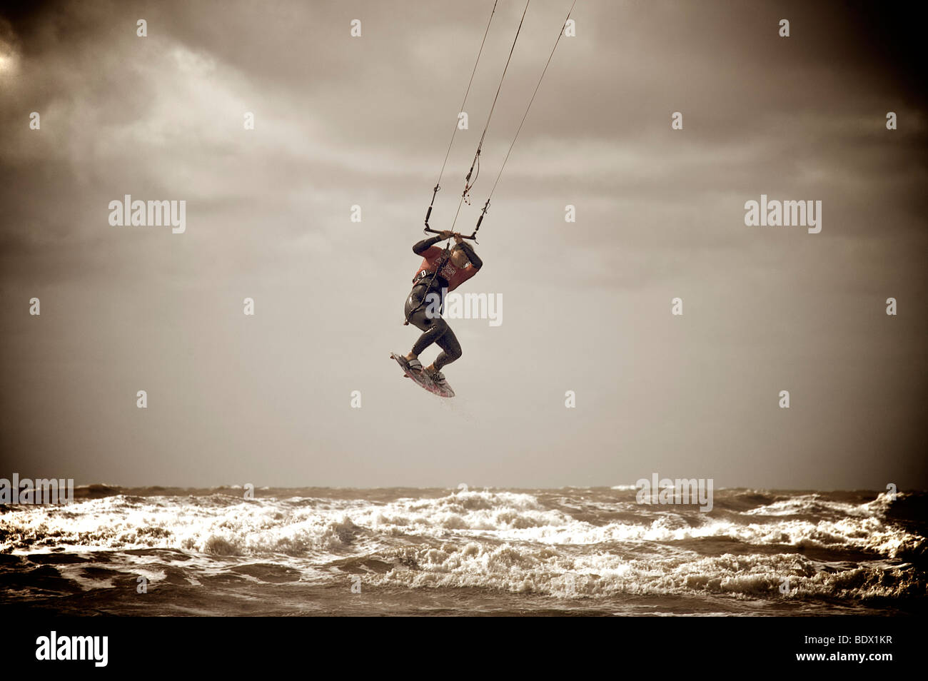 Kite surfer jumping into the air against dramatic back lit sky Stock ...
