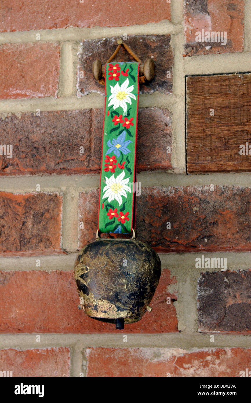 Swiss cow bell hanging on brick wall Stock Photo - Alamy