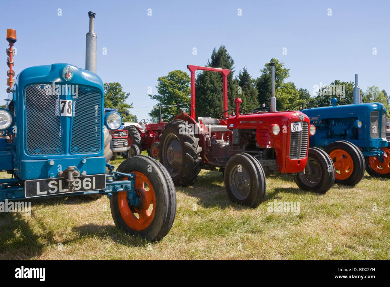 Row of colourful vintage tractors Stock Photo - Alamy
