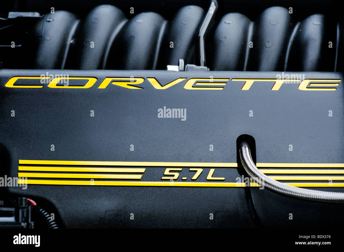 Yellow Chevrolet Corvette name on black 5.7 litre engine casing ...
