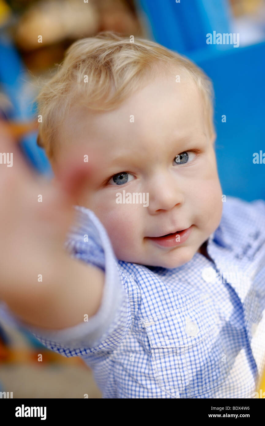 Little boy trying to grab the camera Stock Photo - Alamy