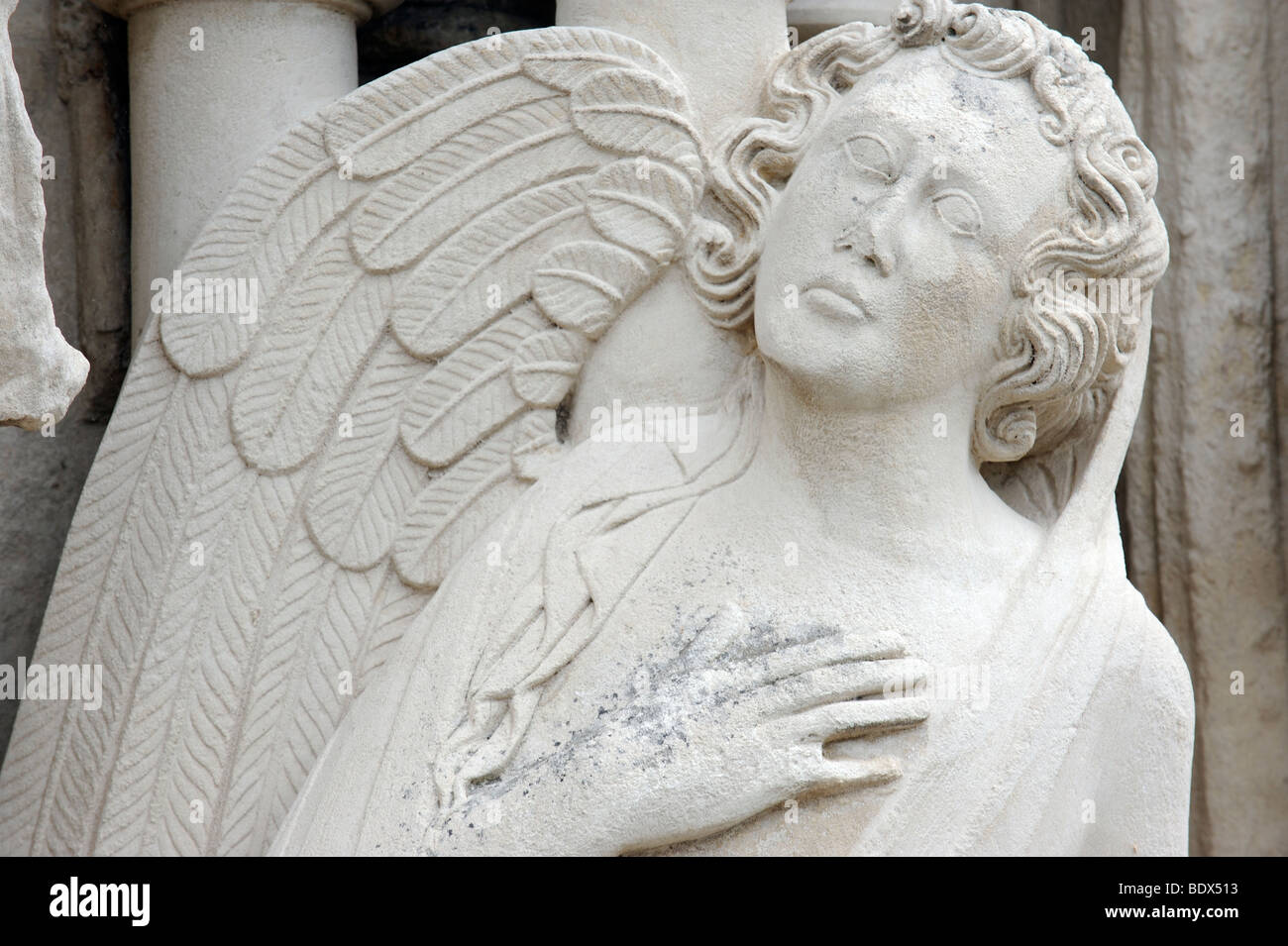 A sculpture of an angel on the facade of Exeter Cathedral in Devon ...