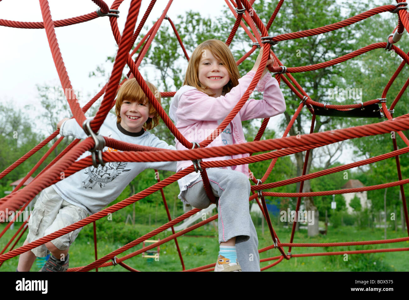 Children climbing at a playground Stock Photo - Alamy
