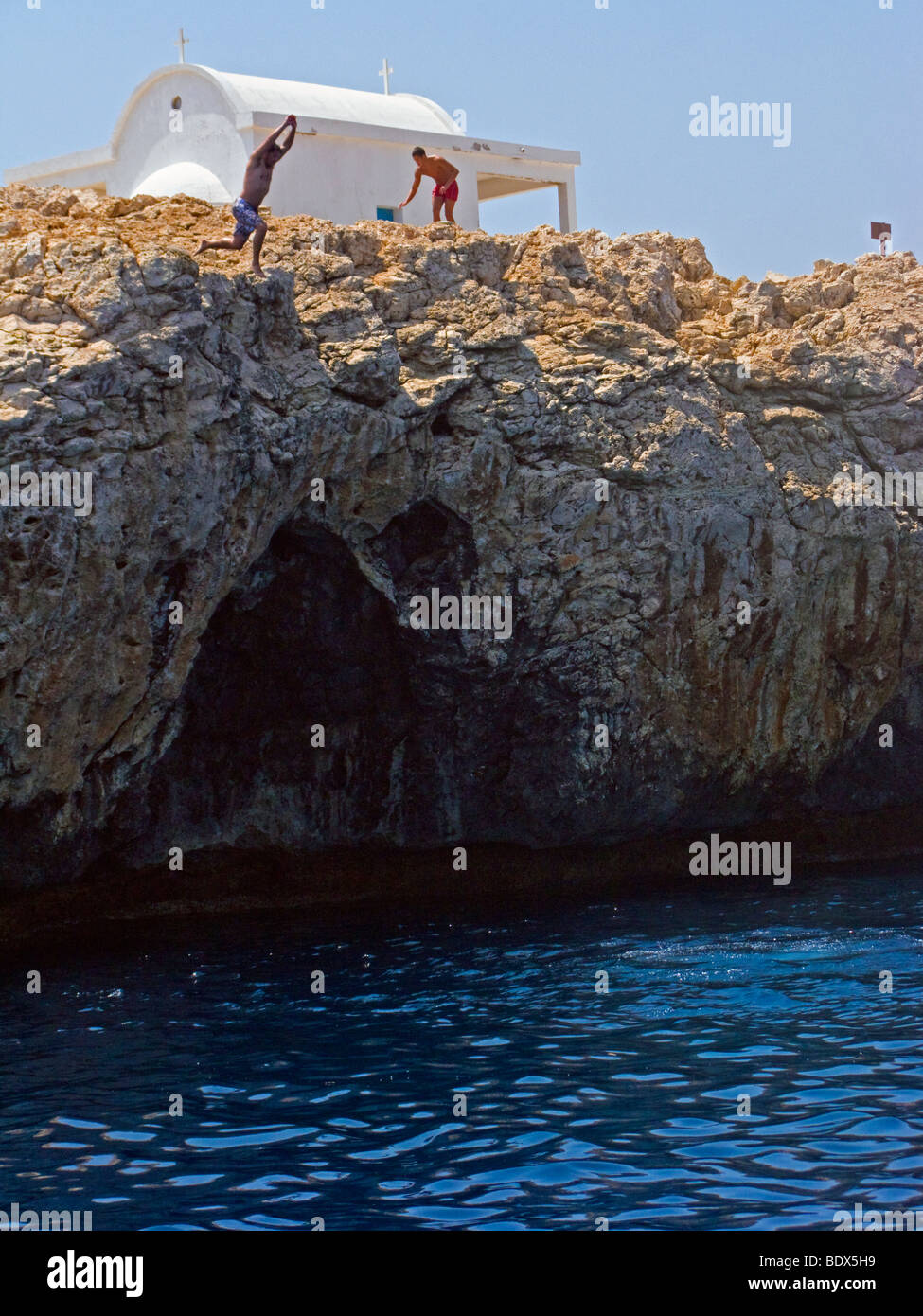 People jumping from the cliff at the small Agioi Anargyroi chapel near ...