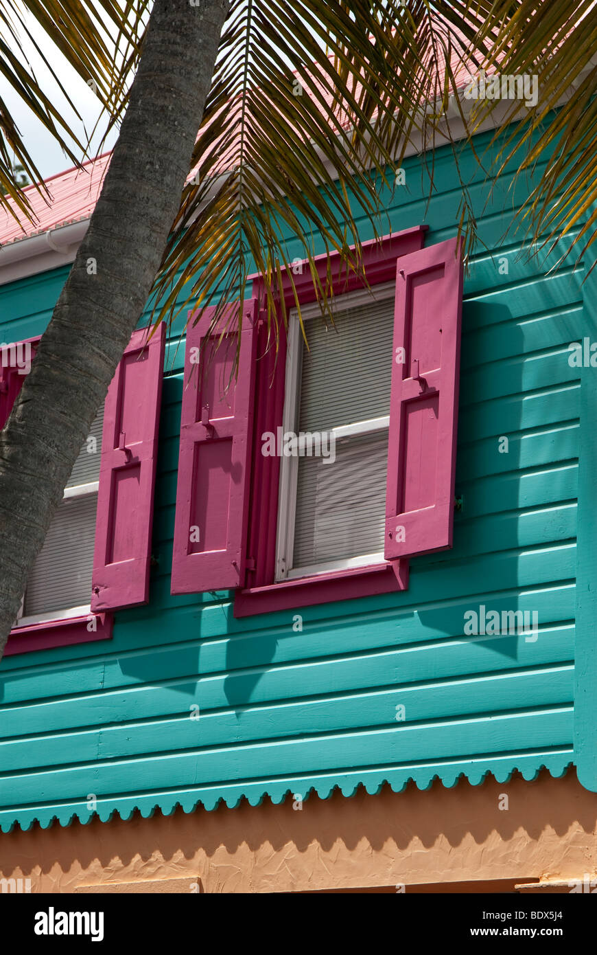 Colourful window shutters on a timber clad building on the Caribbean ...