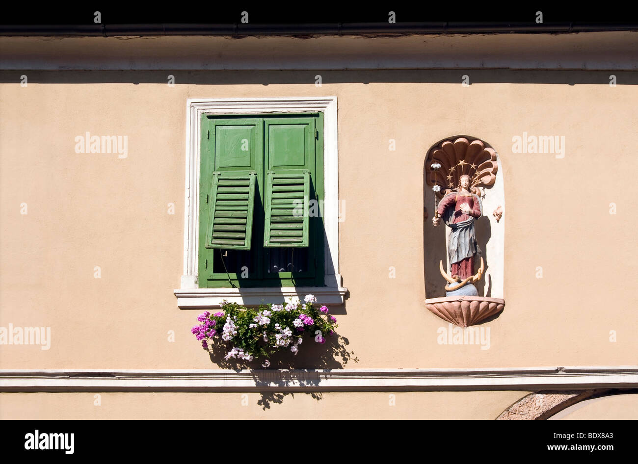Historic window with shutters and holy statue in Bad Radkersburg ...